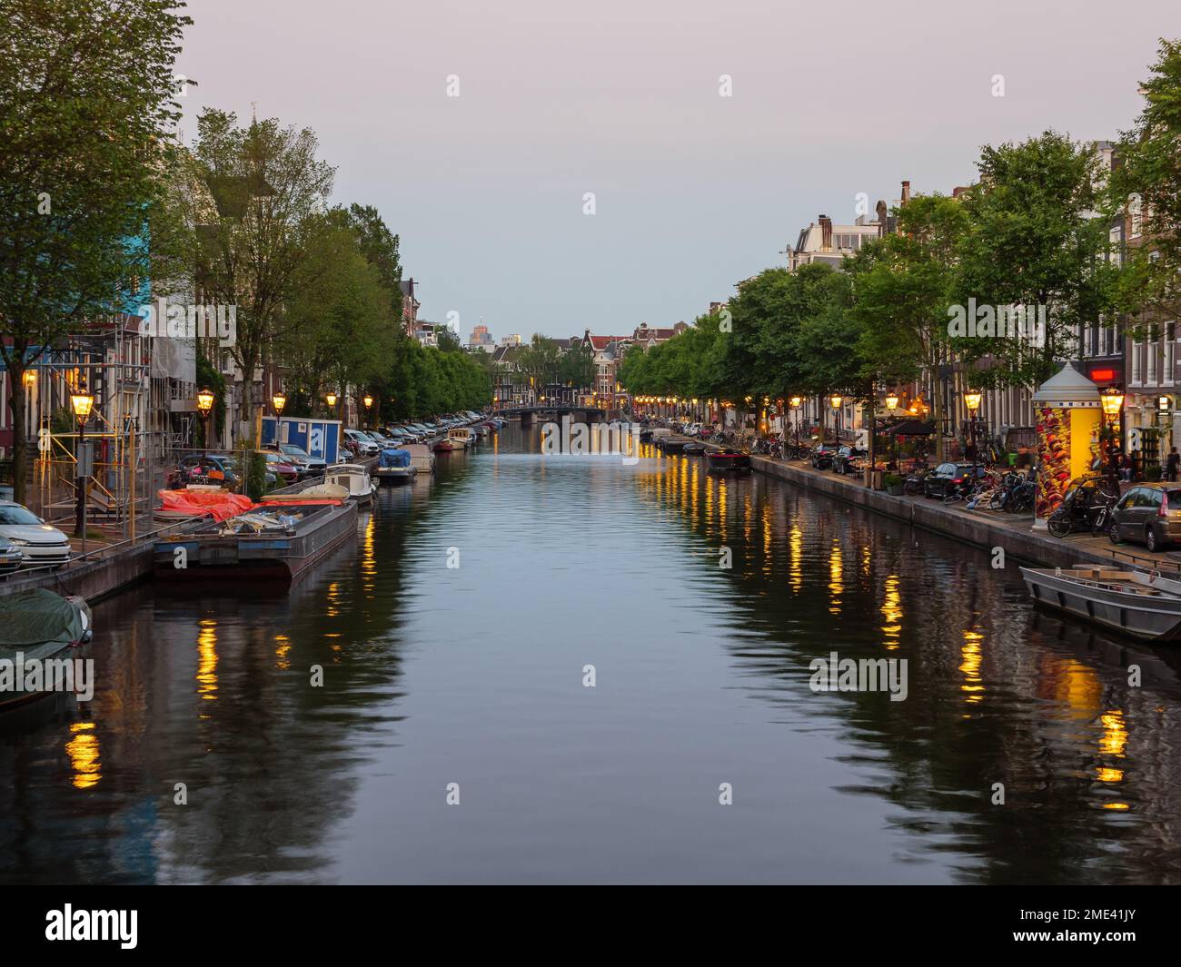 A scenic view of a narrow empty lake with buildings on the side Stock ...