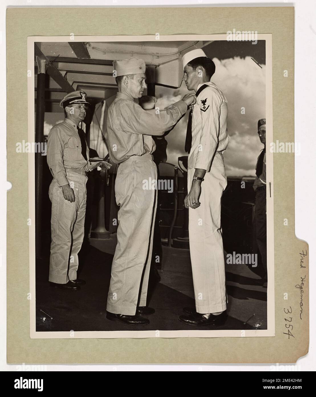 Coast Guard Captain Charles Dean of Pascagoula, Mississippi, awards a ...