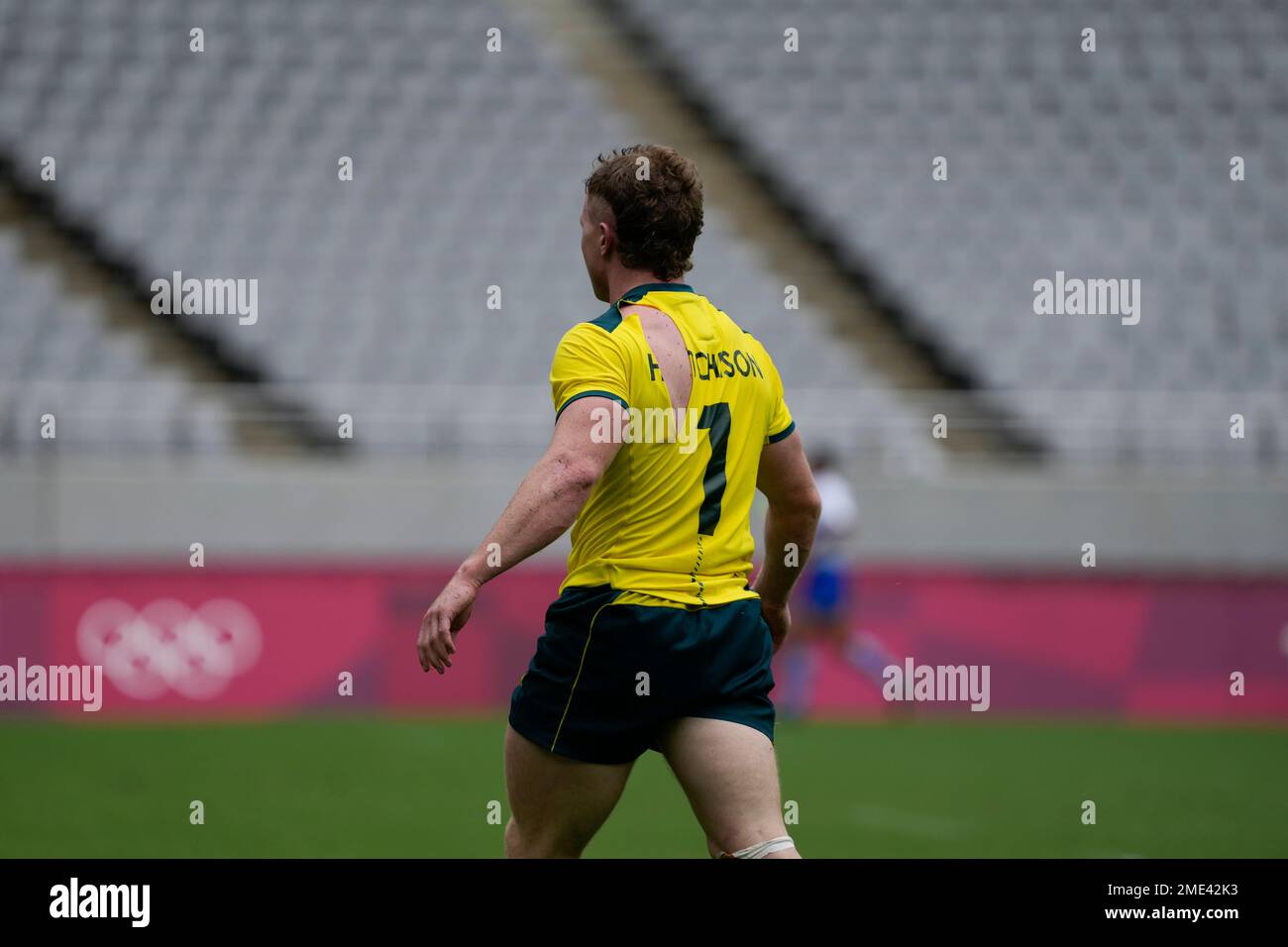 Australia's Henry Hutchison walks on the pitch with a torn shirt during ...