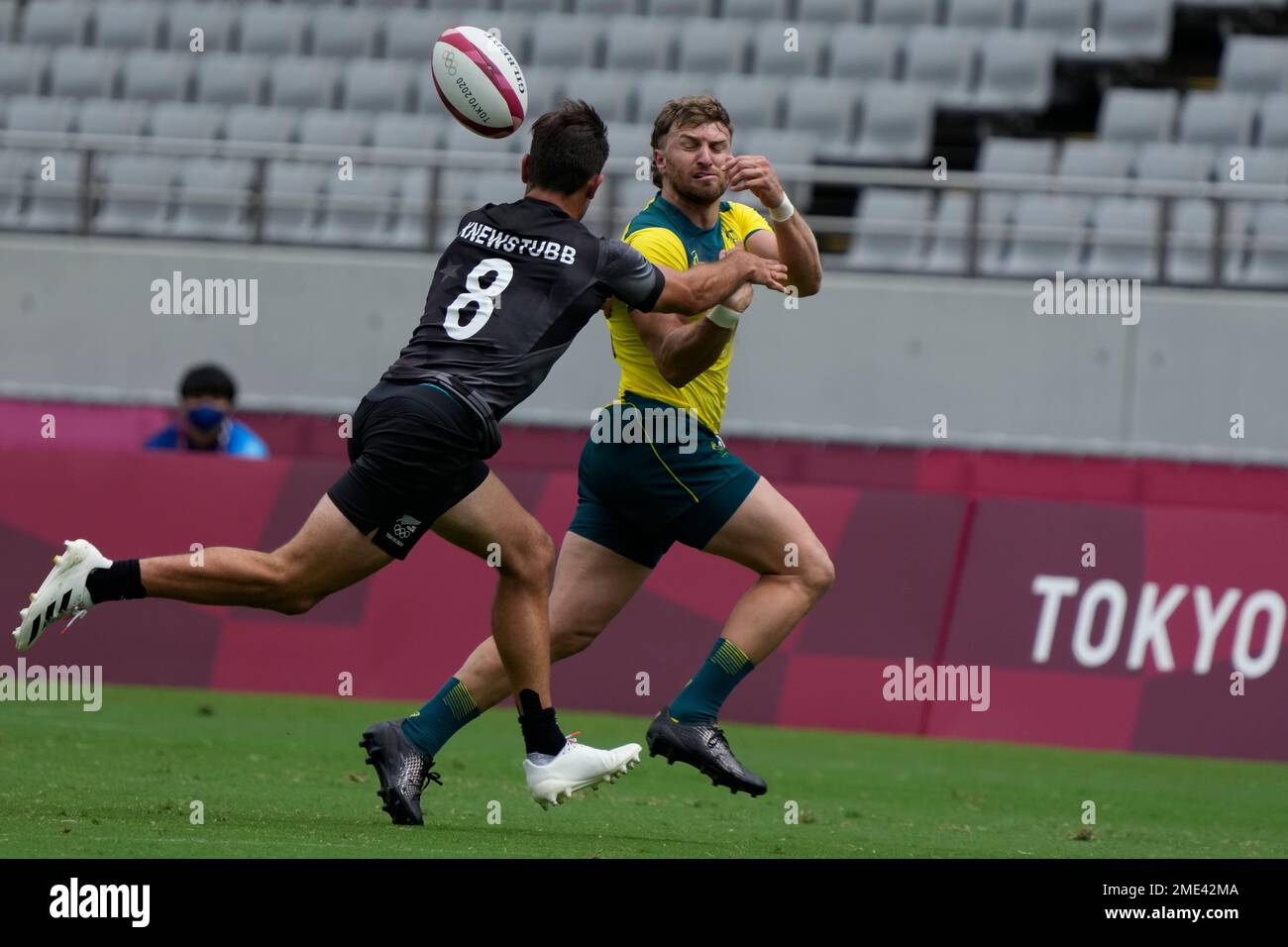 Australia's Lewis Holland, right, gets off a pass under pressure from ...