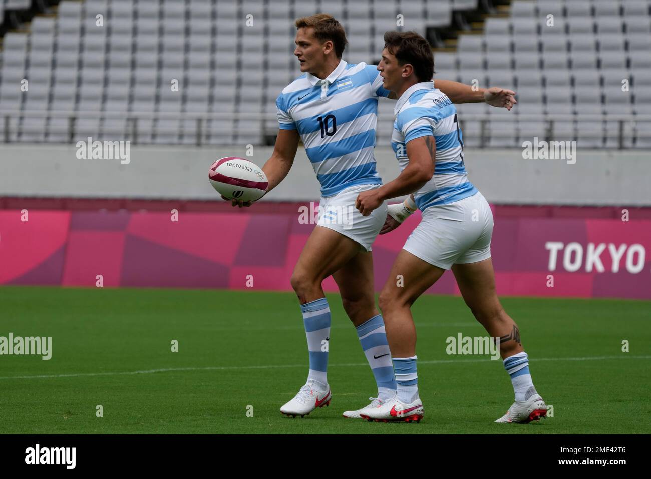 Argentina's Santiago Mare, left, and Rodrigo Isgro celebrate a try by ...