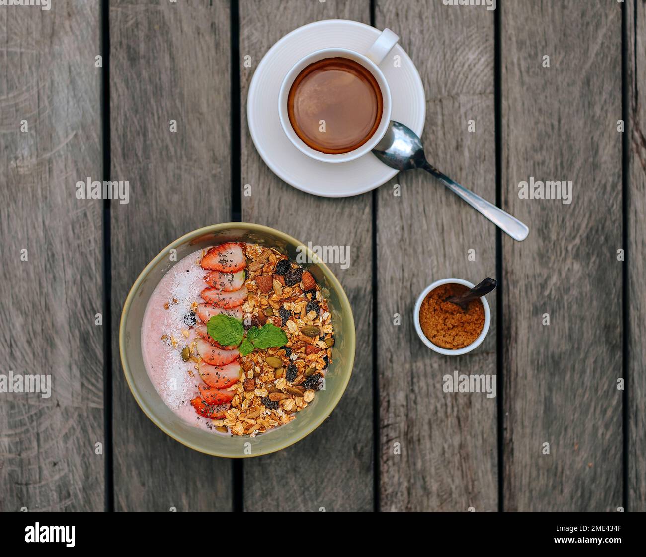 Cup of coffee and bowl of strawberry muesli Stock Photo - Alamy