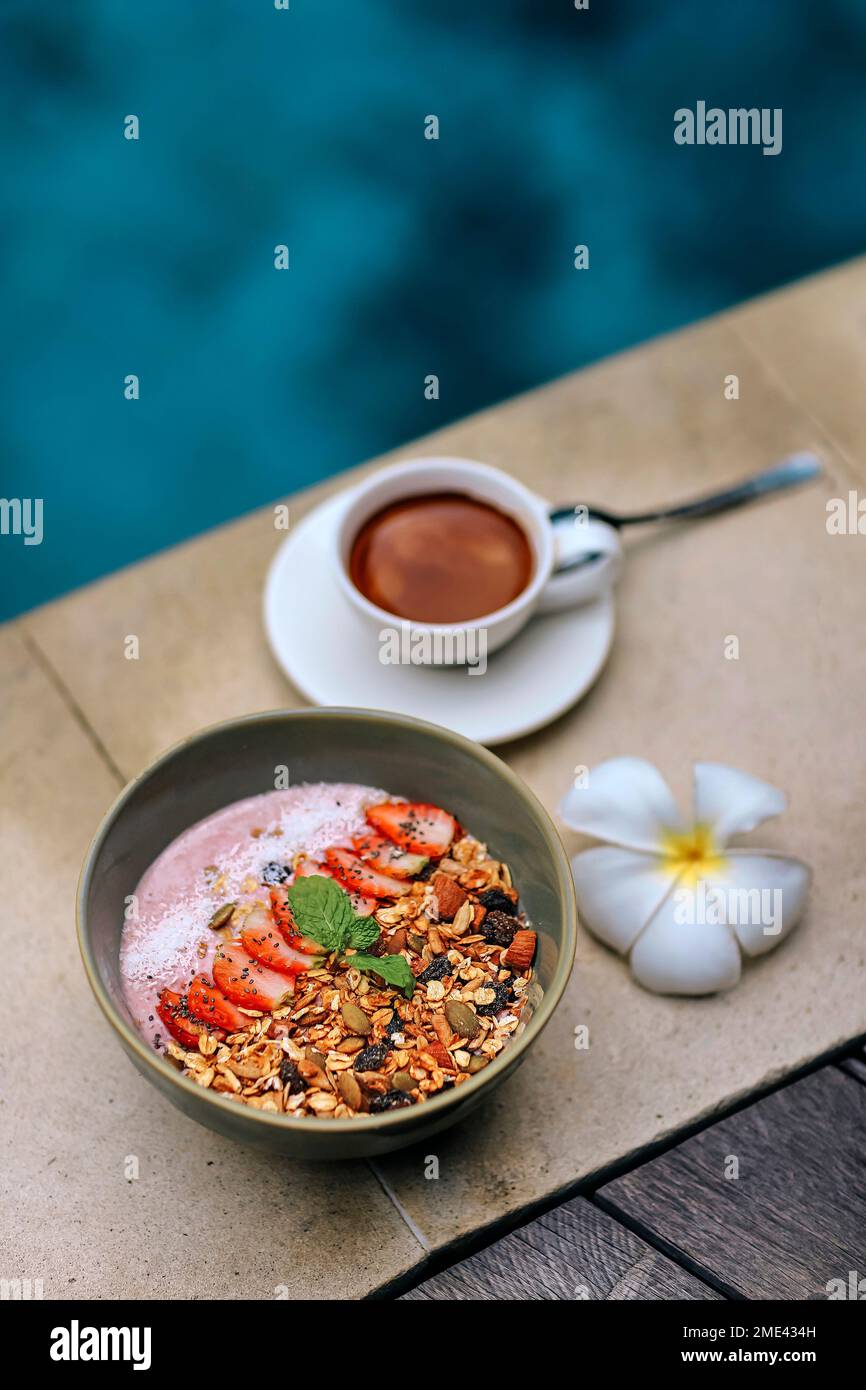 Cup of coffee and bowl of pitaya muesli Stock Photo - Alamy