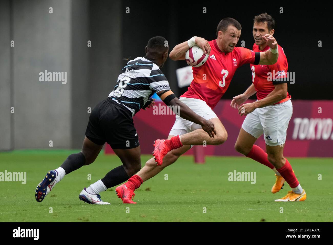 Britain's Alex Davis, center, is pursued by Fiji's Waisea Nacuqu in ...