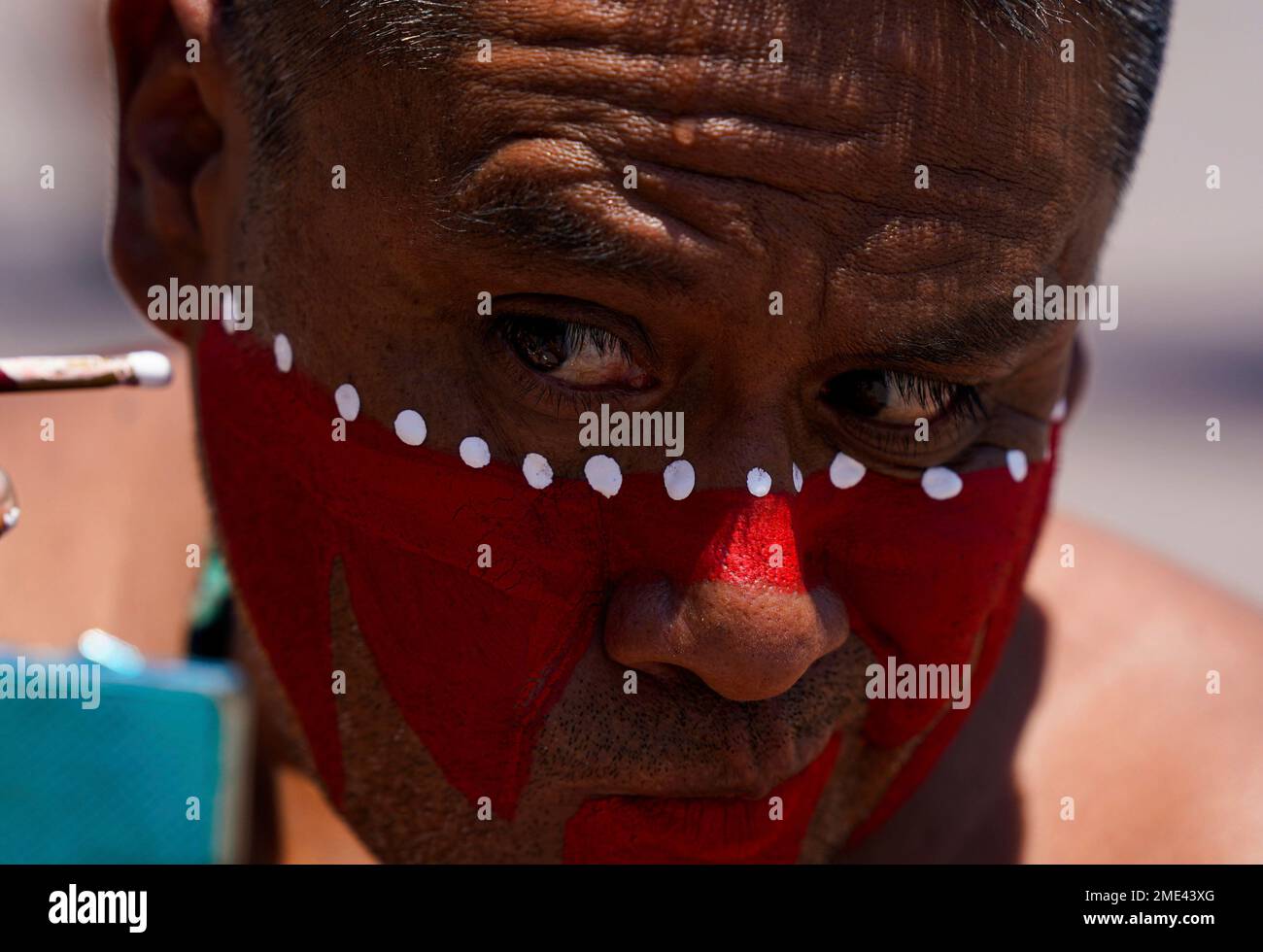 A dancer applies makeup prior a performance as part of the ...
