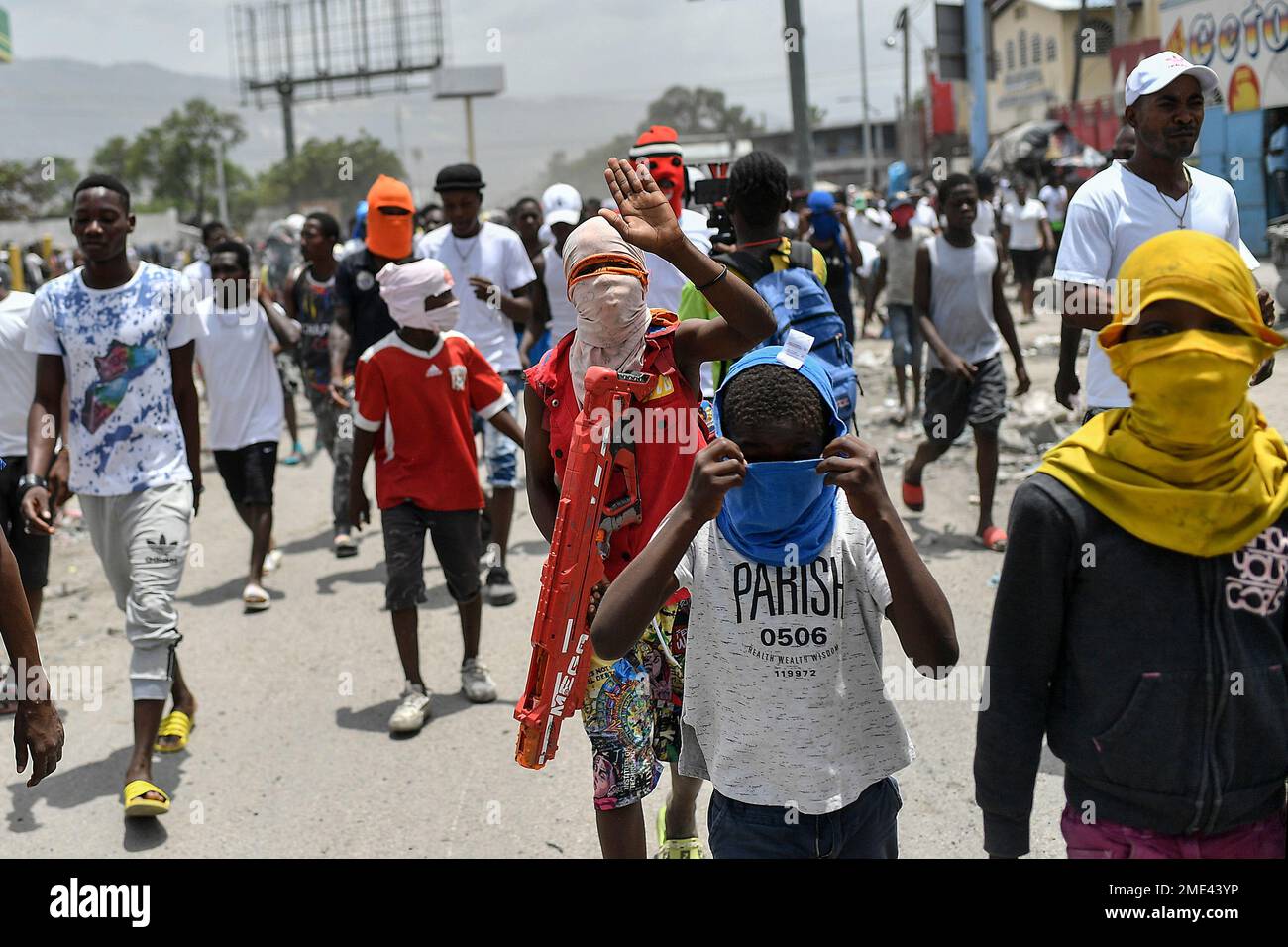Children and youths join a march by members of the gang led by Jimmy ...