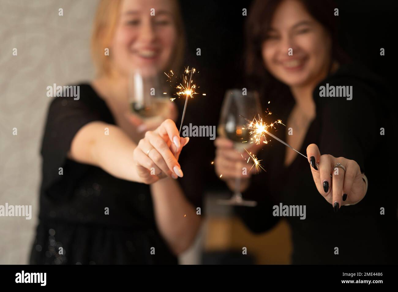 Happy young women celebrating holding hi-res stock photography and ...