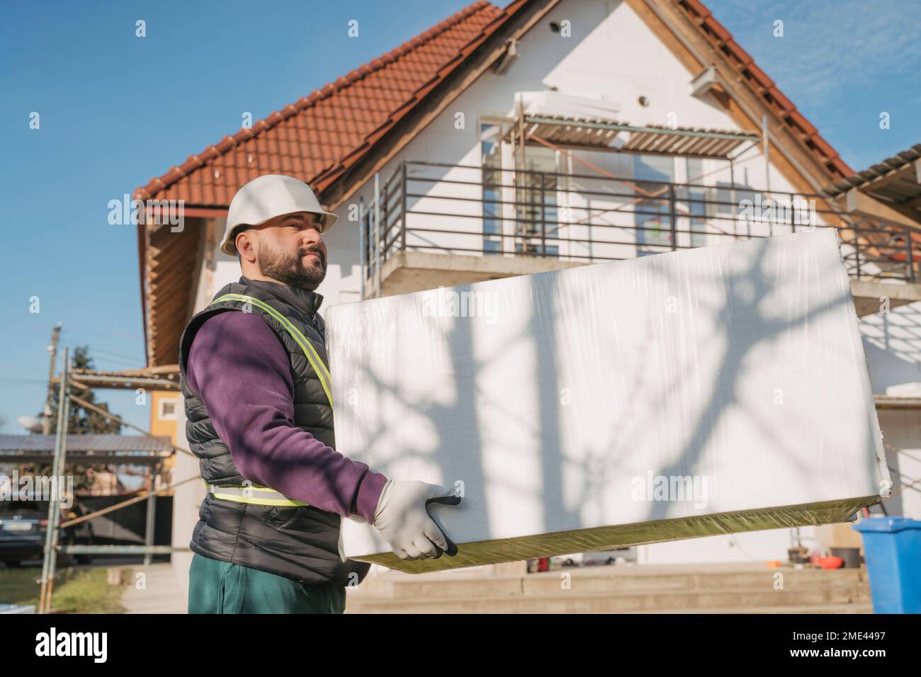 Construction worker holding polystyrene foam in front of house Stock ...