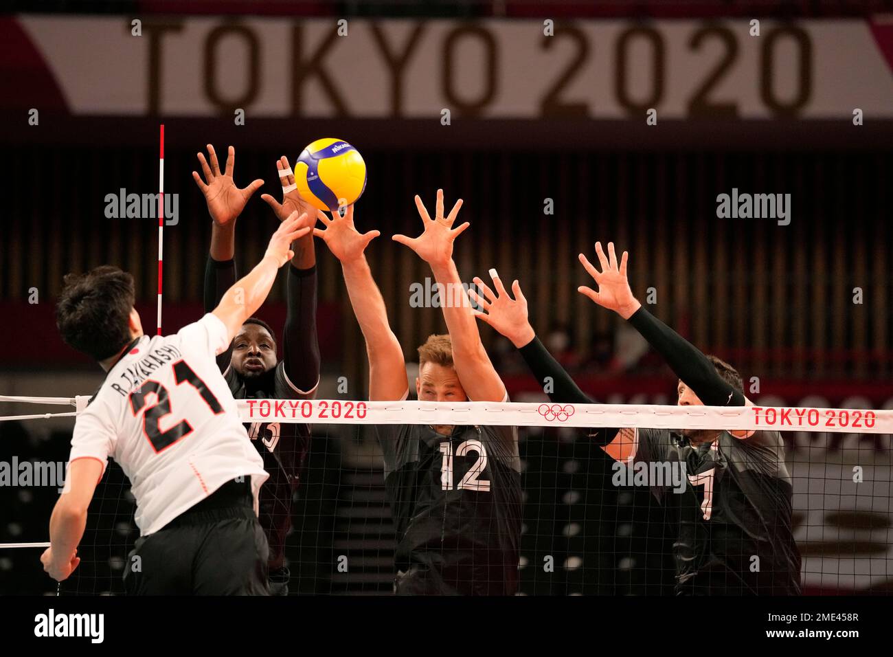 Japan's Ran Takahashi spikes a ball against Canada's Sharone Vernon ...