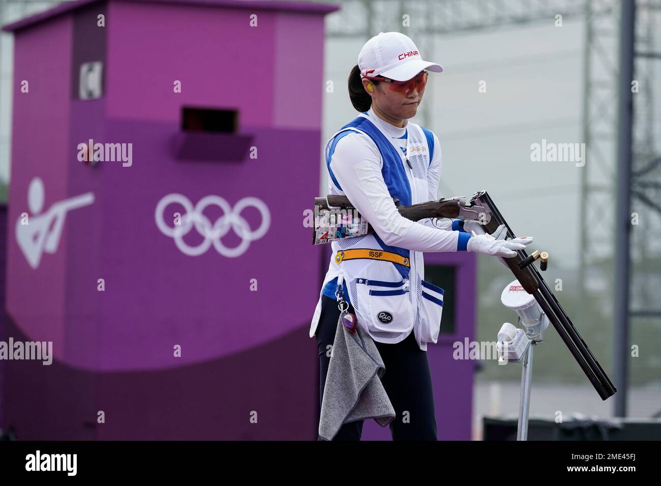 Wei Meng, of China, tosses her shells as she competes in the women's ...