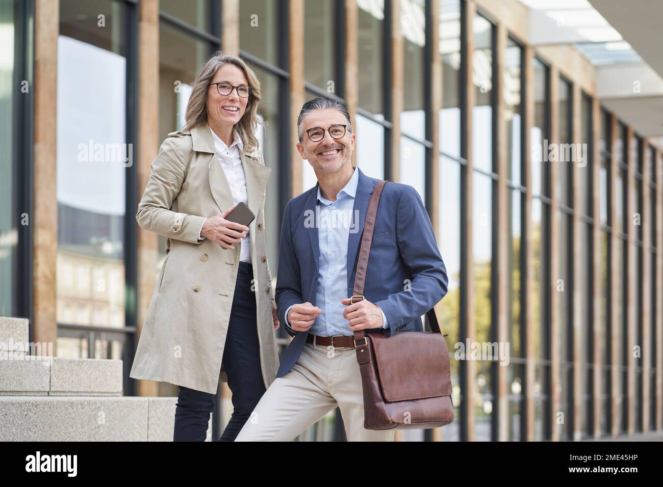 Happy mature business colleagues standing outside building Stock Photo ...