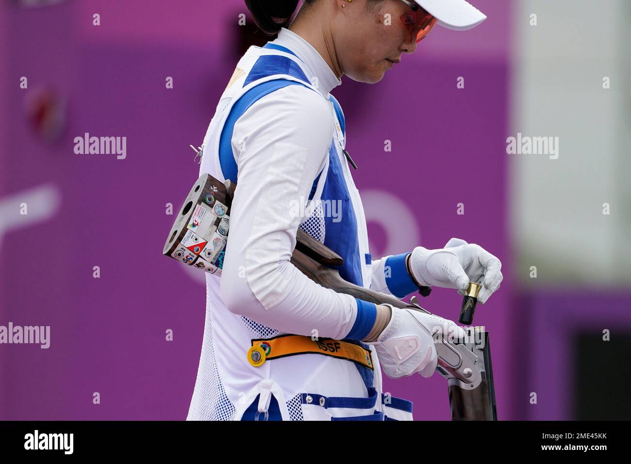 Wei Meng, of China, loads he shells as she competes in the women's ...