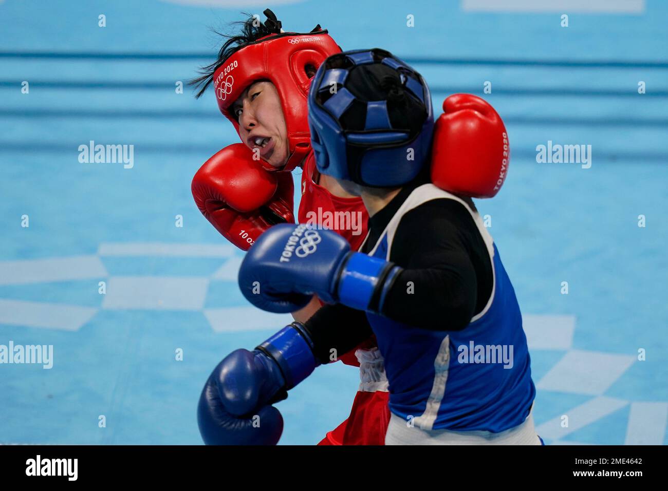 Japan's Sena Irie, left, takes a pinch from Tunisia's Khouloud Hlimi Ep ...
