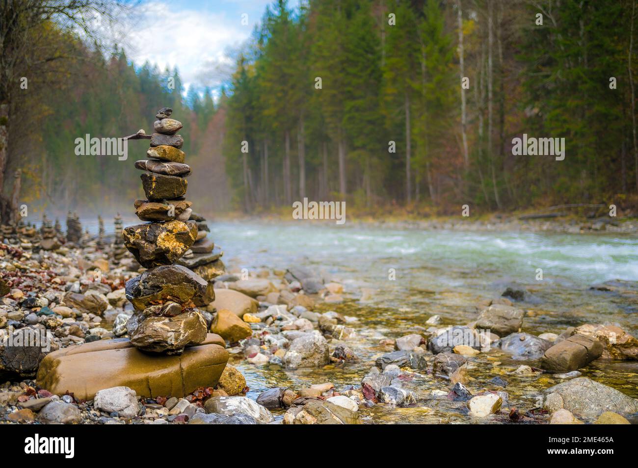 Stack of pebbles at riverbank Stock Photo - Alamy