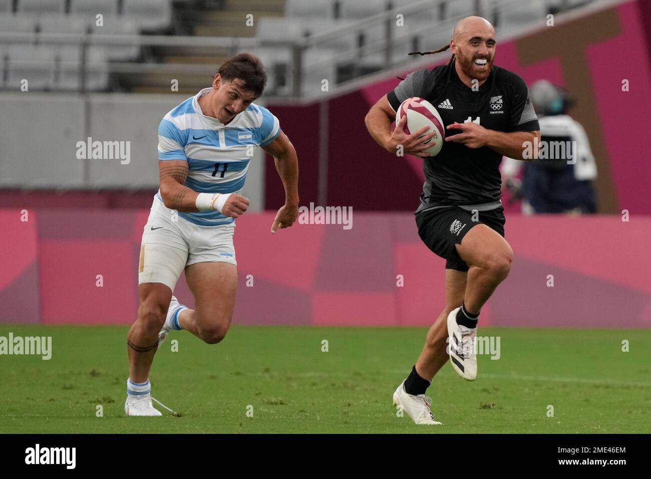 New Zealand's Joe Webber is pursued by Argentina's Luciano Gonzalez ...