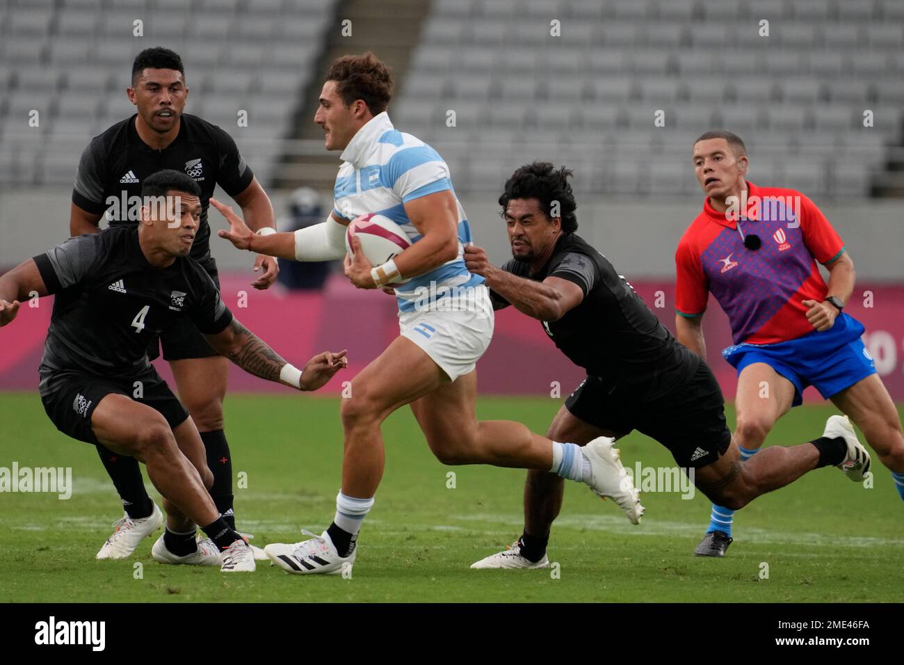 Argentina's Rodrigo Isgro is pursued by New Zealand's Regan Ware, right ...