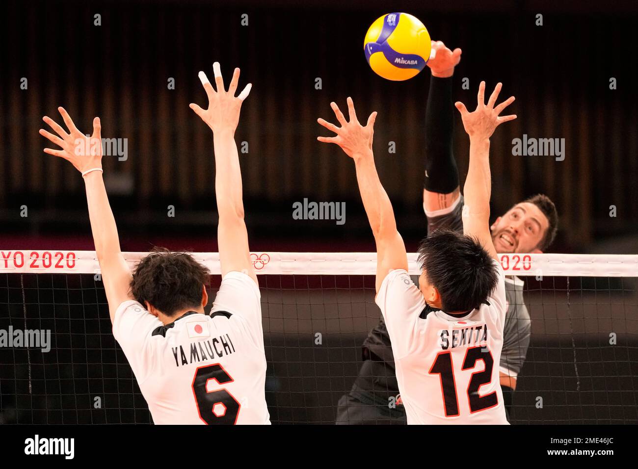 Japan's Akihiro Yamauchi and Masahiro Sekita try to block a spike by ...