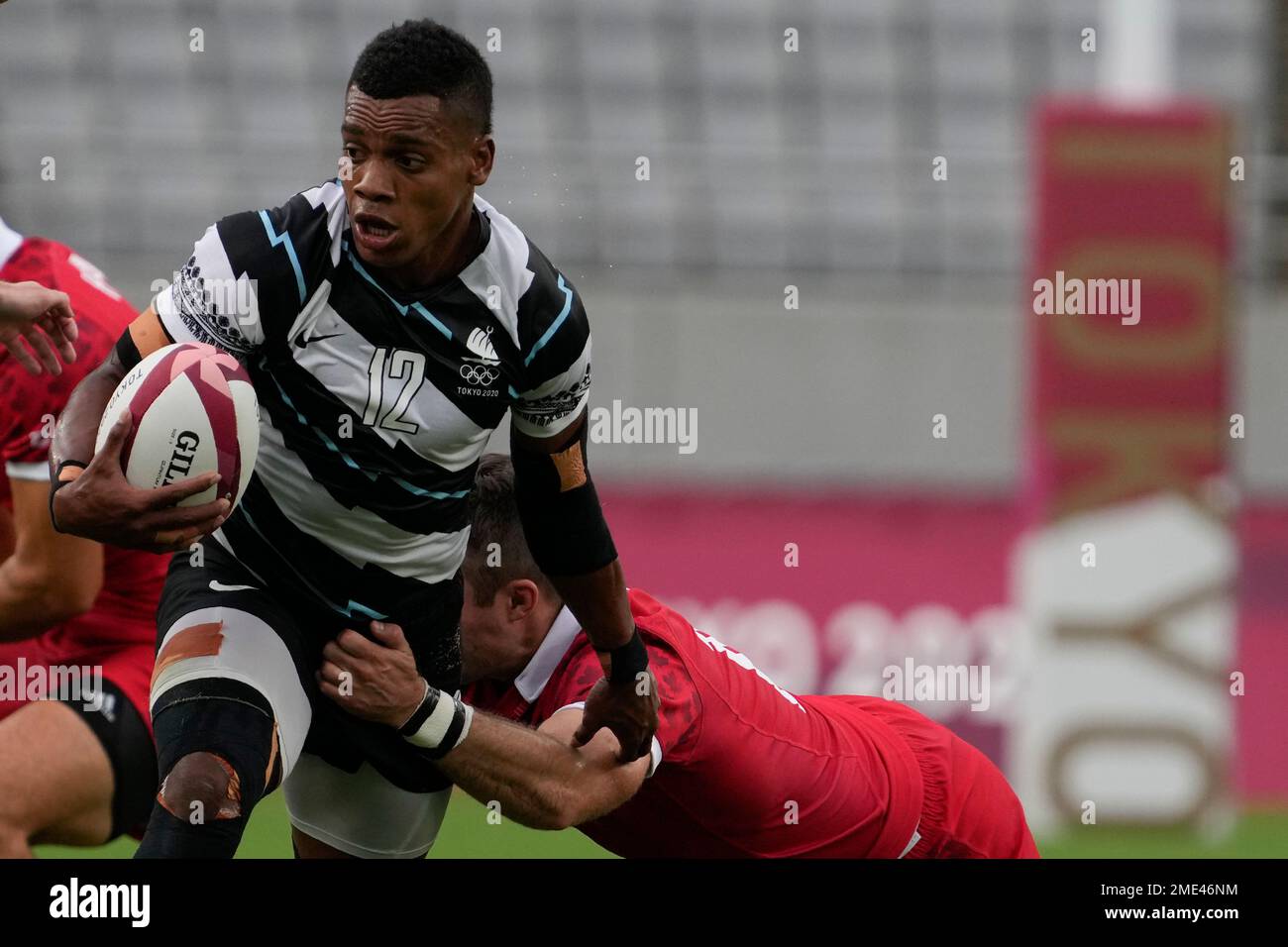 Fiji's Napolioni Bolaca is tackled by Canada's Pat Kay in their men's ...