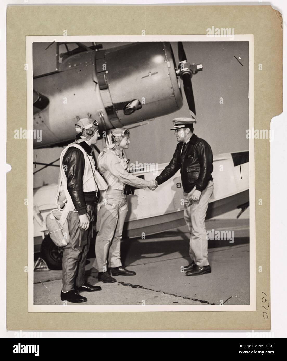 A Coast Guardsman stands with aviators, highlighting the close ...