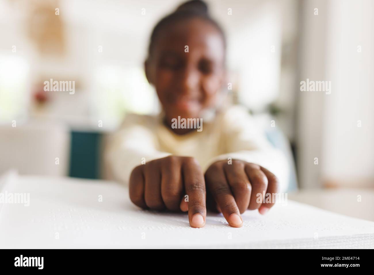 Blind african american girl reading braille Stock Photo - Alamy