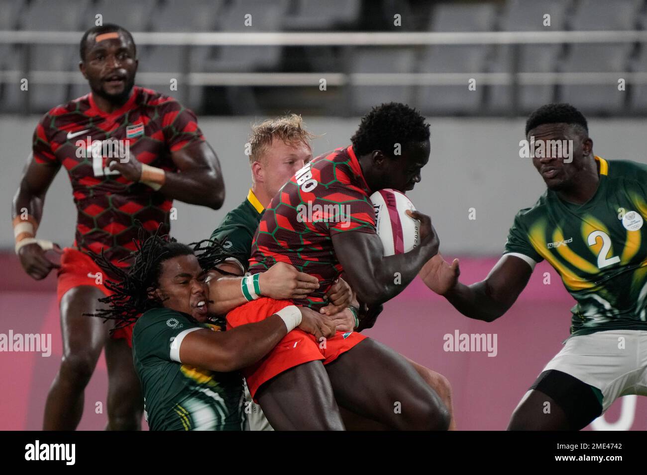 Kenya's Billy Odhiambo, center, is brought down by South Africa's ...