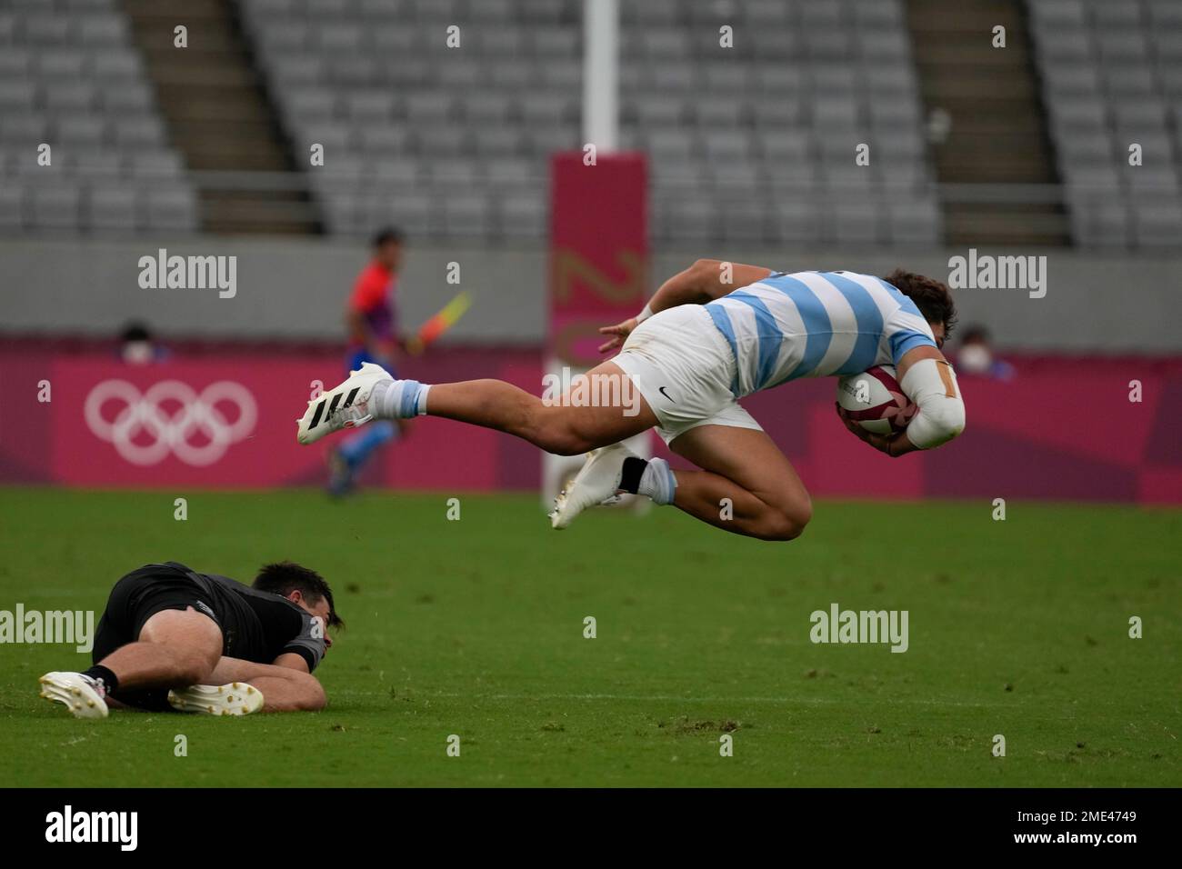 Argentina's Rodrigo Isgro goes flying after a tackle by New Zealand's ...