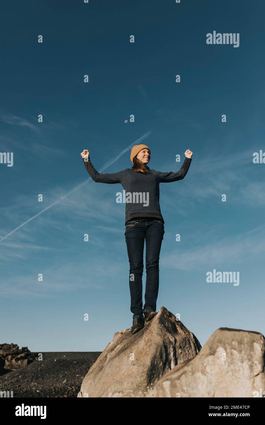 Woman flexing muscles standing rock janubio beach hi-res stock ...
