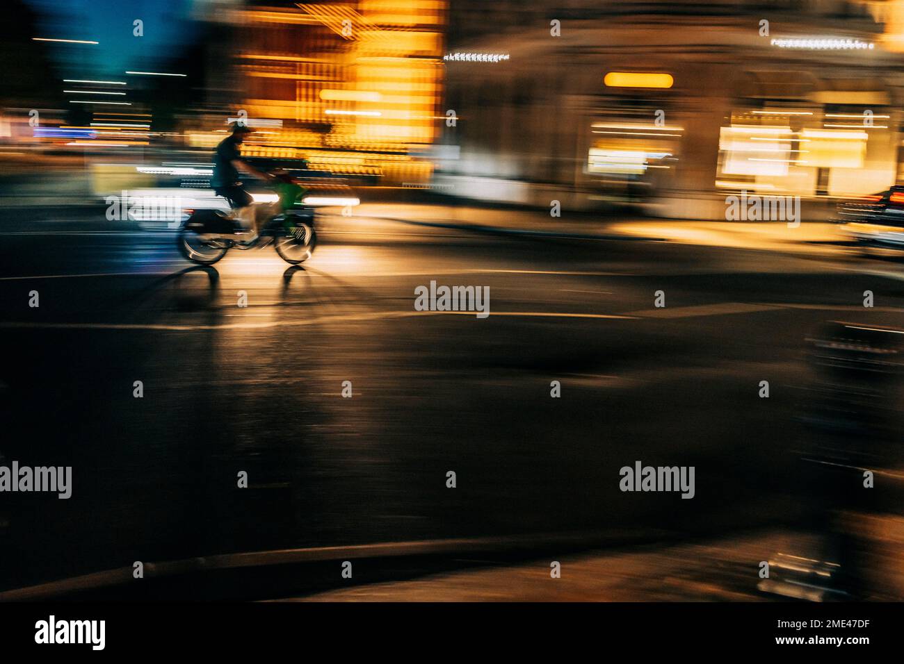 UK, England, London, Blurred motion of person riding motorcycle along ...
