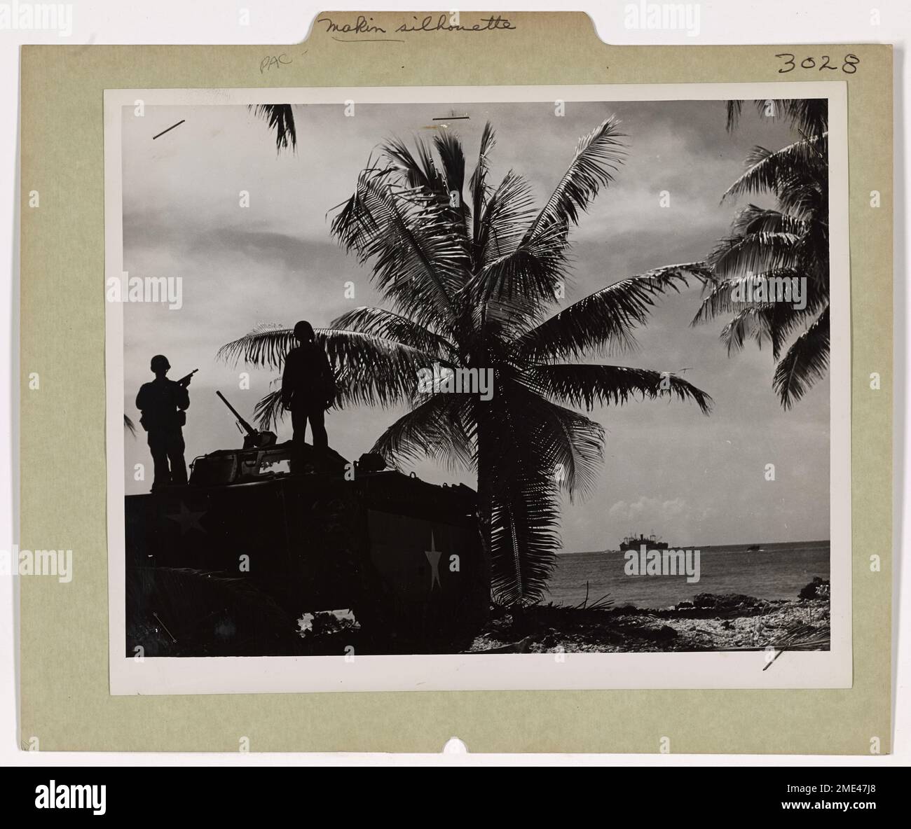 A U.S. Coast Guard photographer captures a silhouette of an amphibious ...