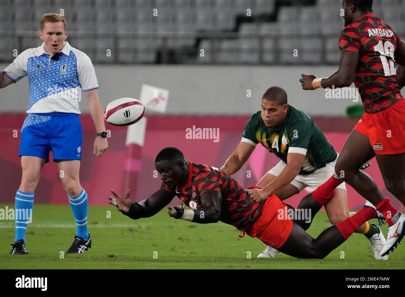 South Africa's Zain Davids tackles Kenya's Andrew Amonde in their men's ...