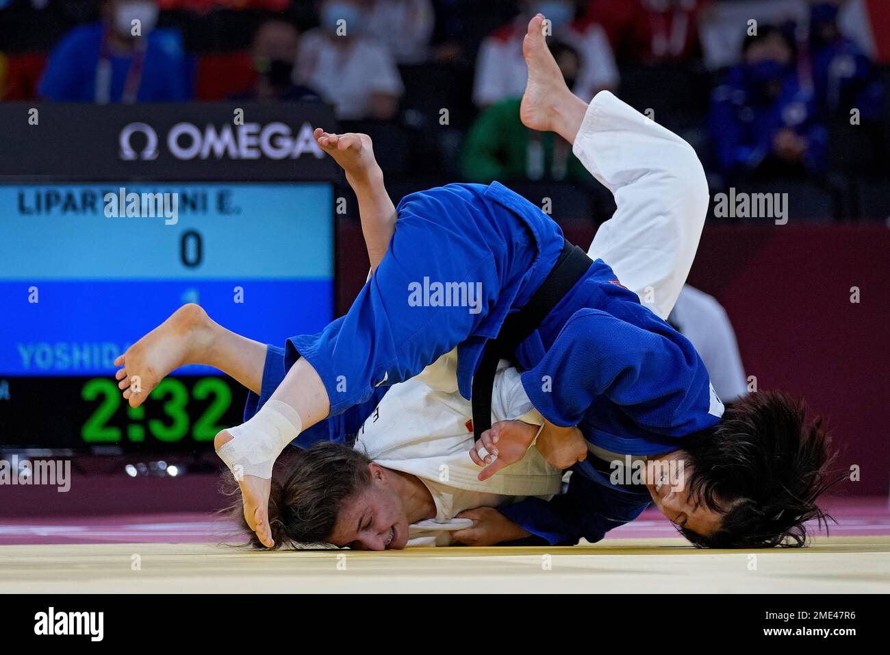 Tsukasa Yoshida of Japan, top, and Eteri Liparteliani of Georgia compete during their women's ...