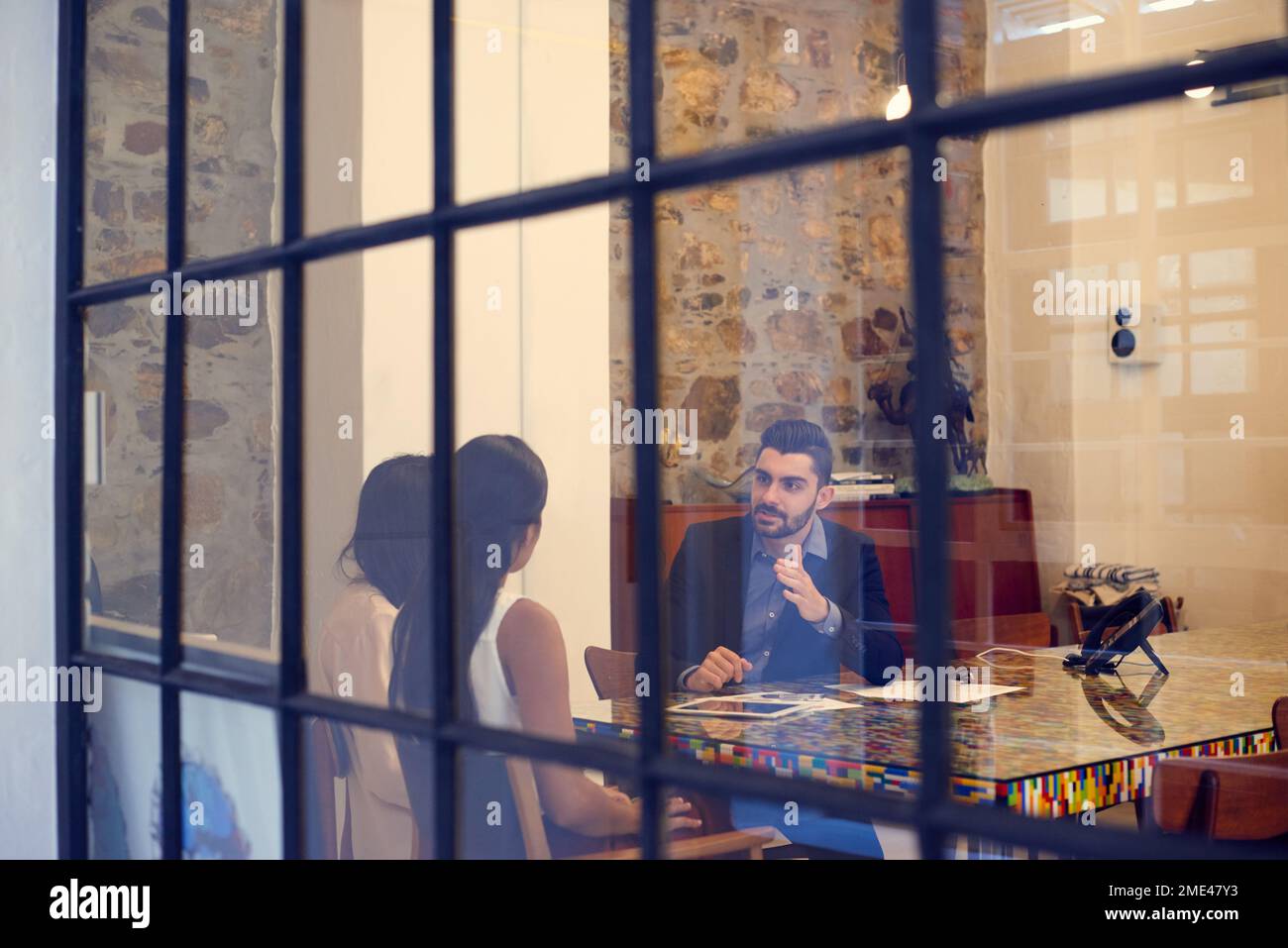 Presenting his master idea. a young businessman giving a presentation ...