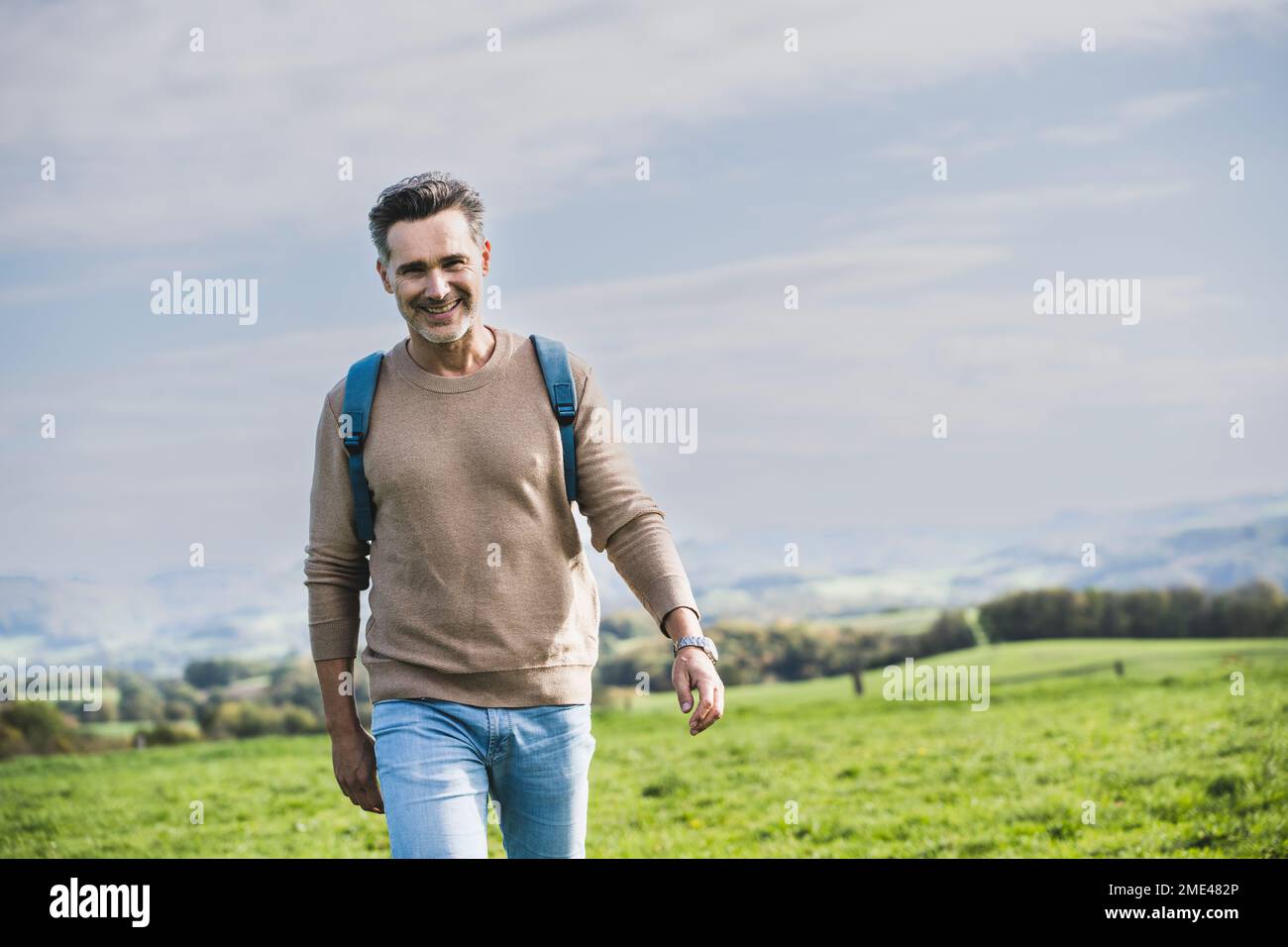 Happy man walking camera hi-res stock photography and images - Alamy