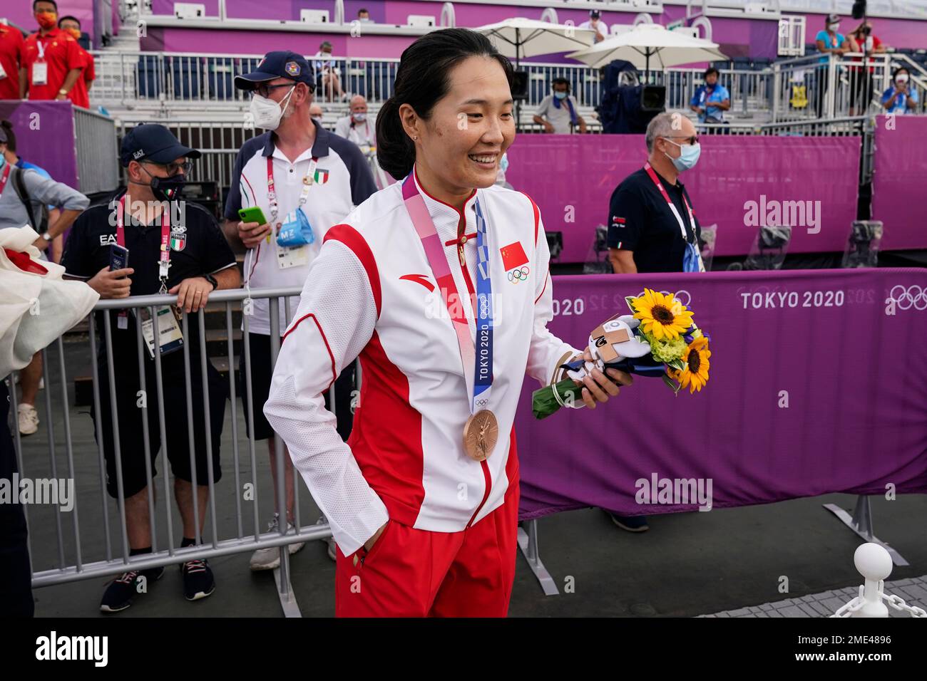 Bronze medalist Wei Meng, of China, celebrates after the women's skeet ...