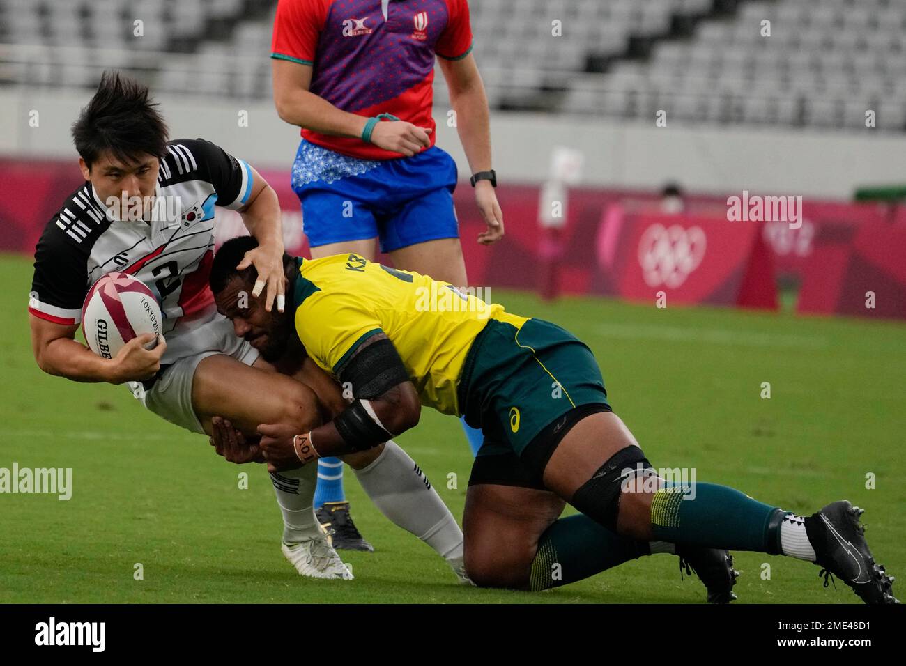 South Korea's Kim Hyun-soo is tackled by Australia's Samu Kerevi in ...