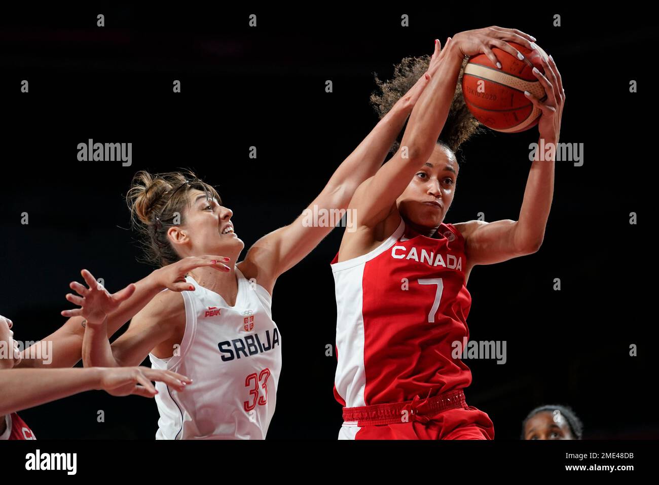 Canada's Nayo Raincock-Ekunwe (7) grabs a rebound over Serbia's Tina ...