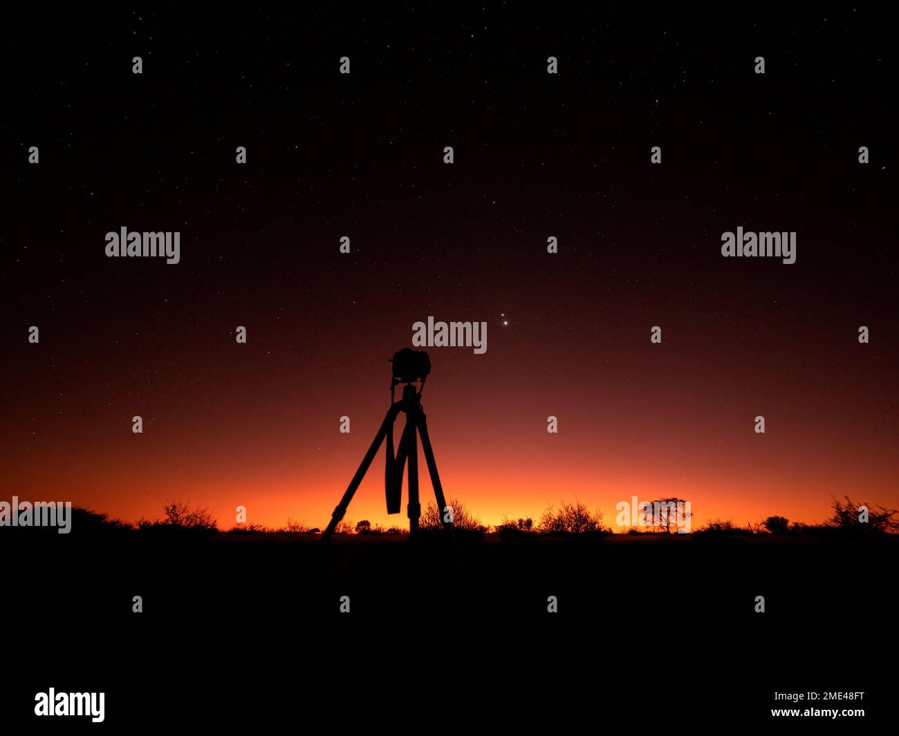 Silhouette of camera tripod standing against moody sky at dawn Stock ...