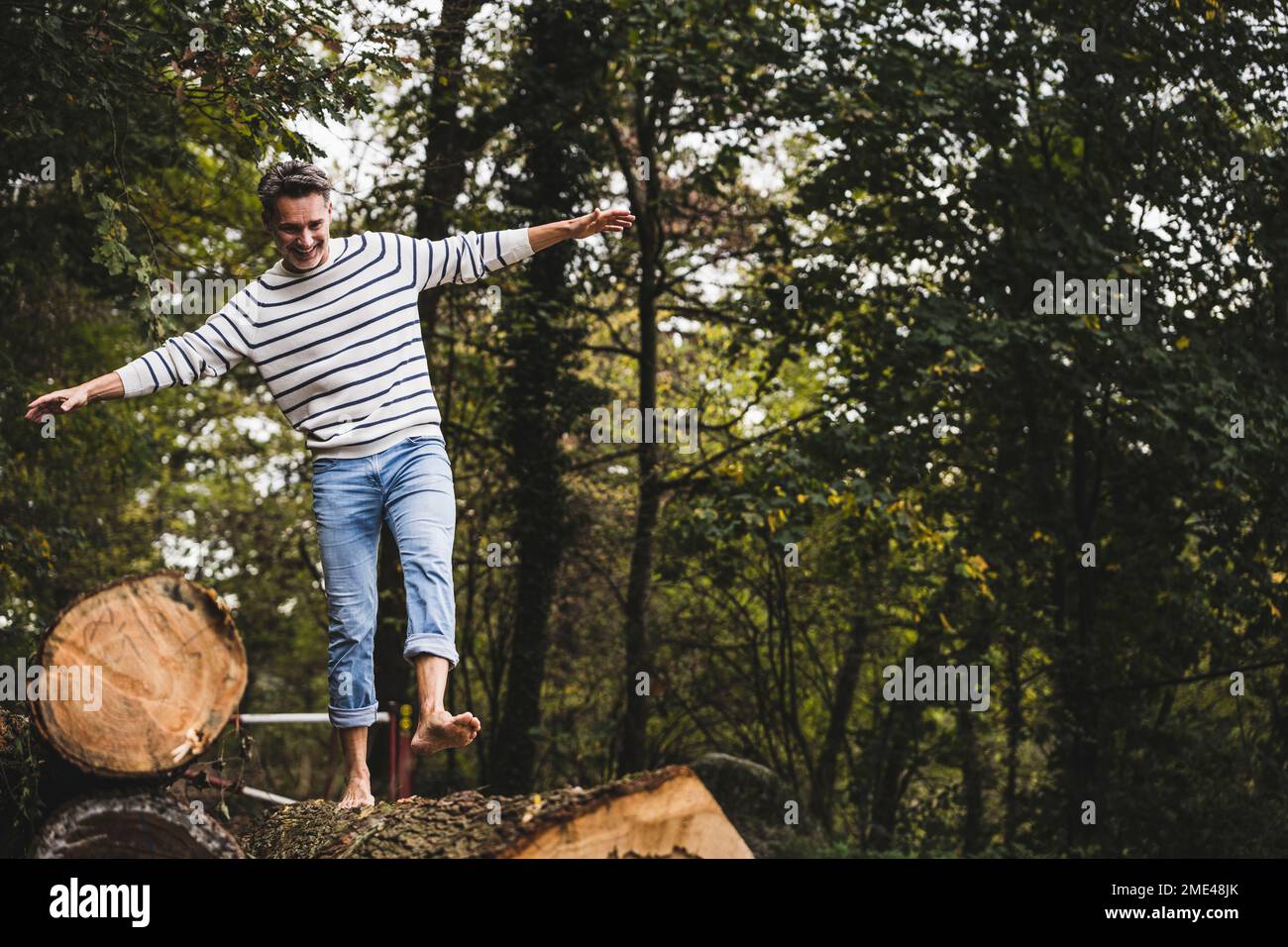 Man walking on log in hi-res stock photography and images - Alamy