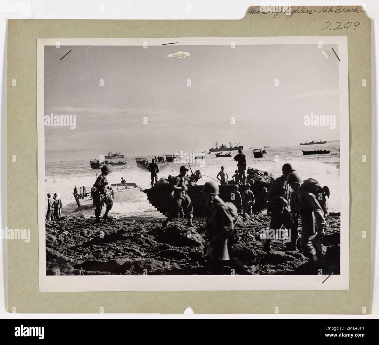 A Coast Guard landing craft charges into the surf, delivering troops ...