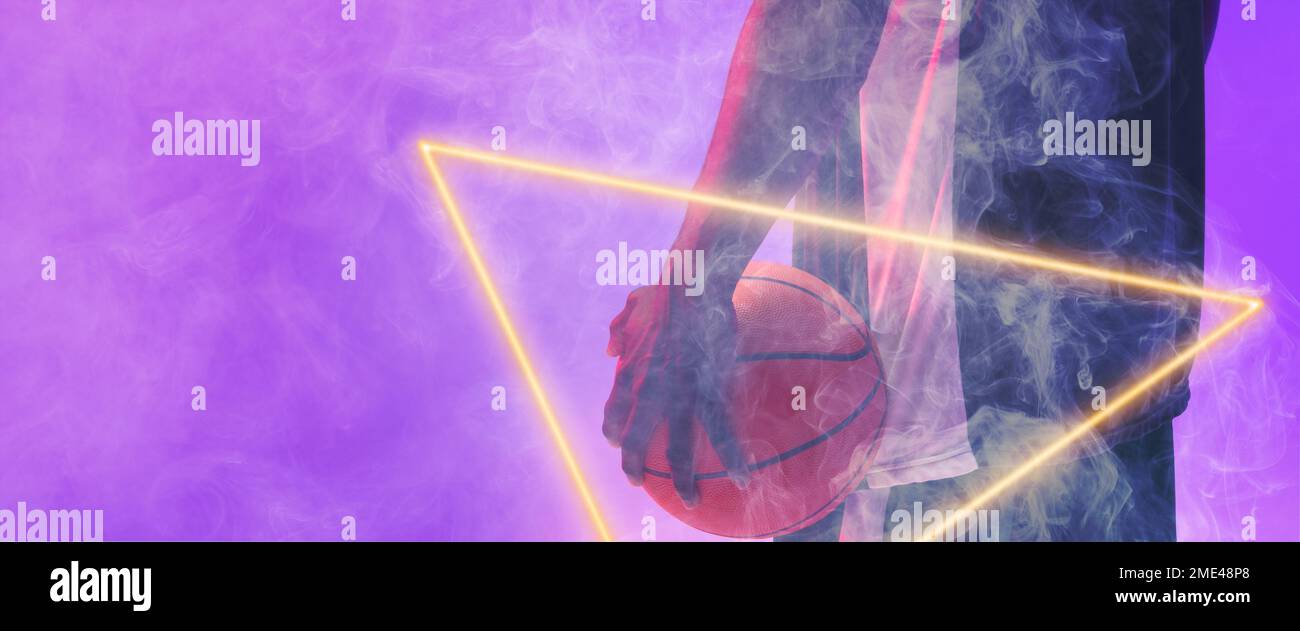Midsection of african american basketball player with ball and glowing ...