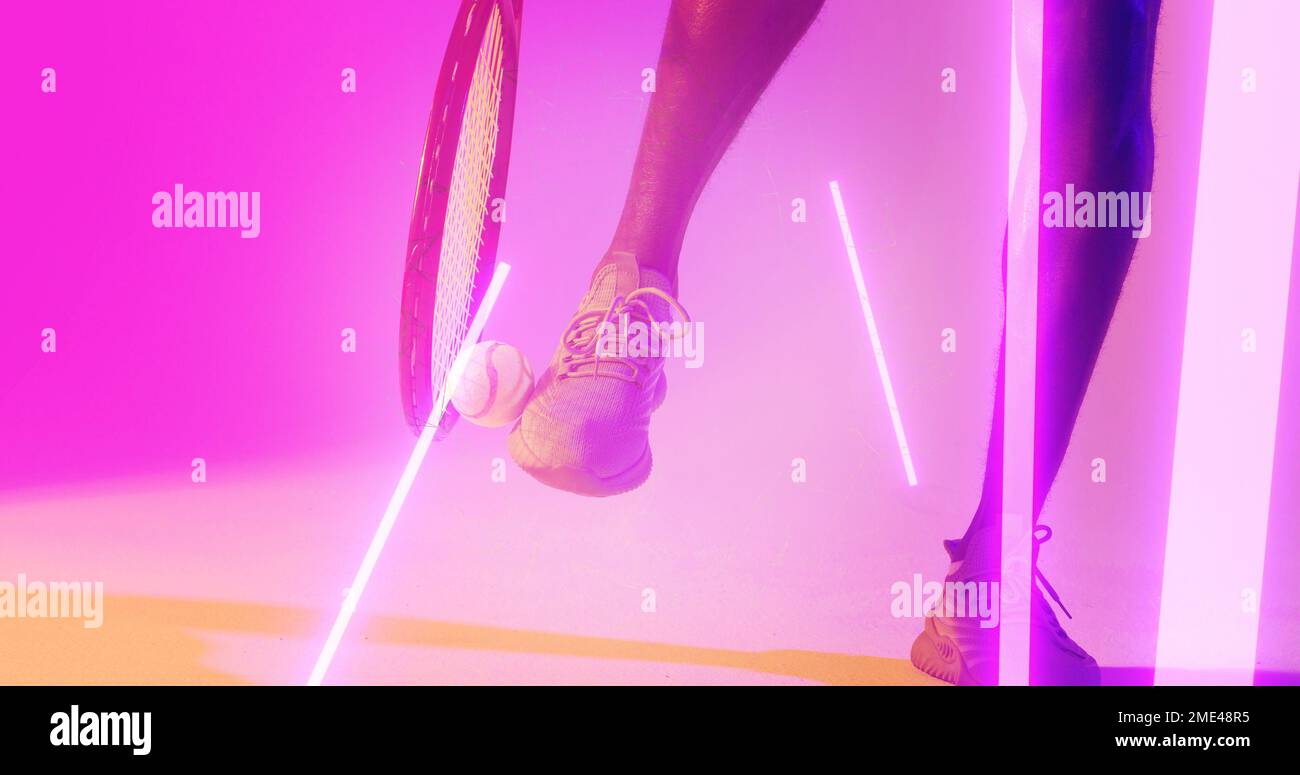 Low section of african american male tennis player with racket kicking ...