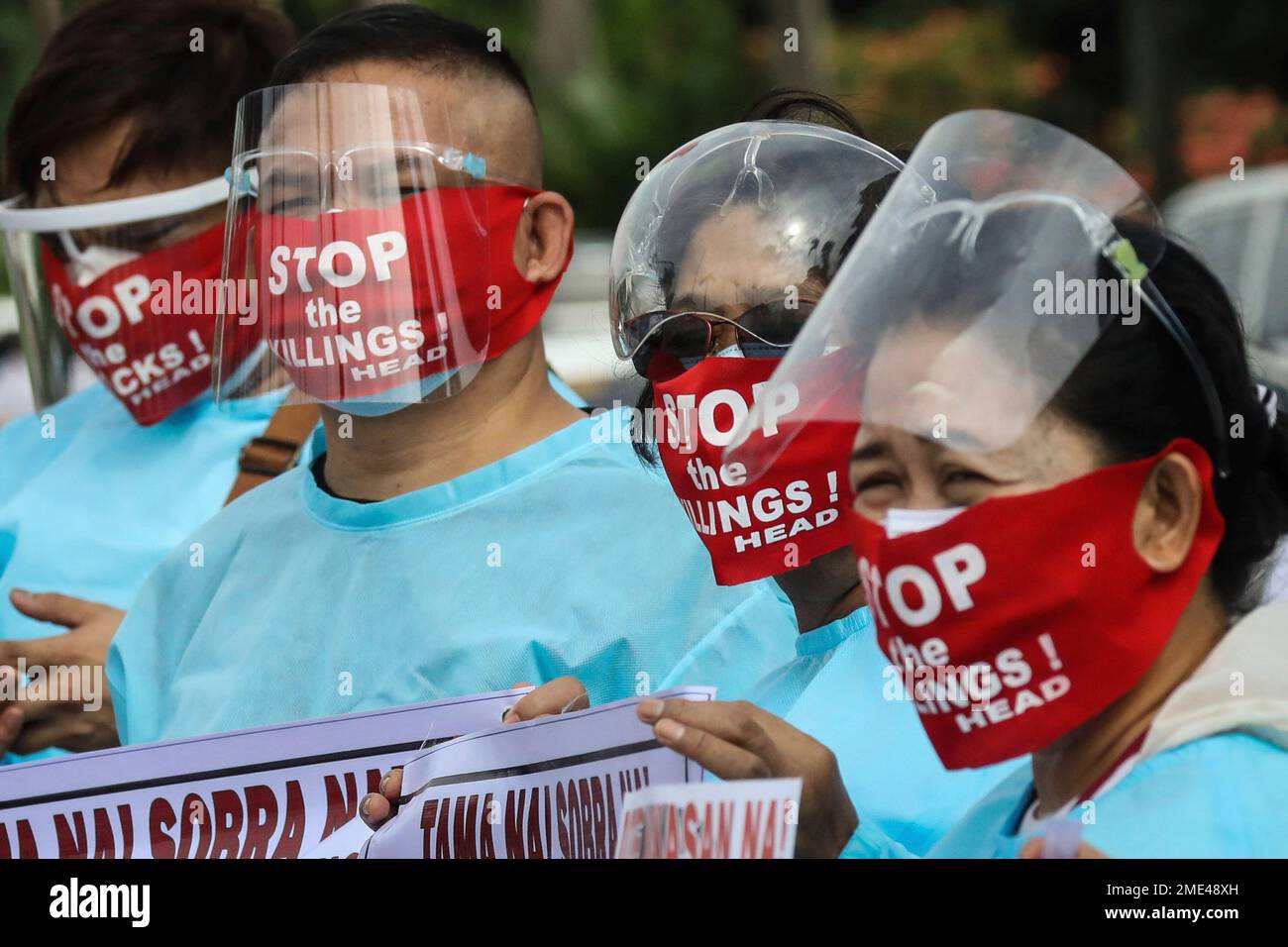 Protesters wear face masks with slogans before marching towards the ...