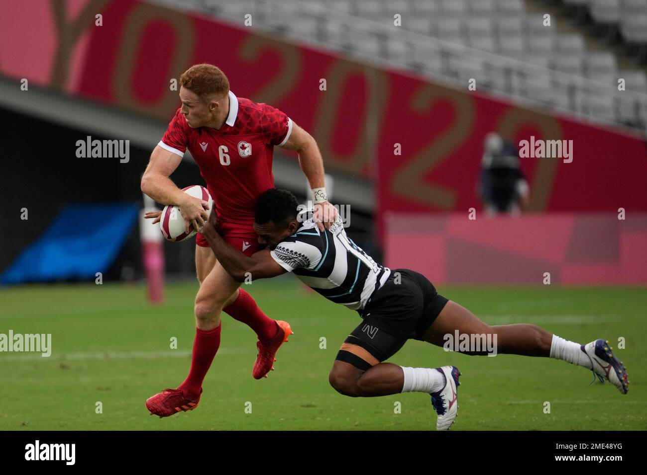 Canada's Connor Braid is tackled by Fiji's Sireli Maqala in their men's ...