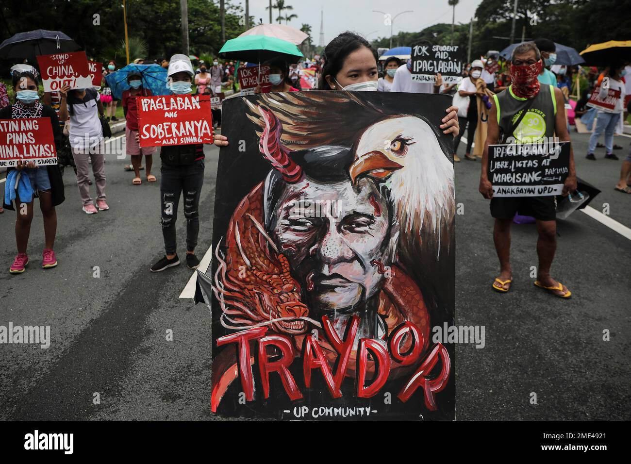A protester holds a slogan bearing the face of Philippine President ...