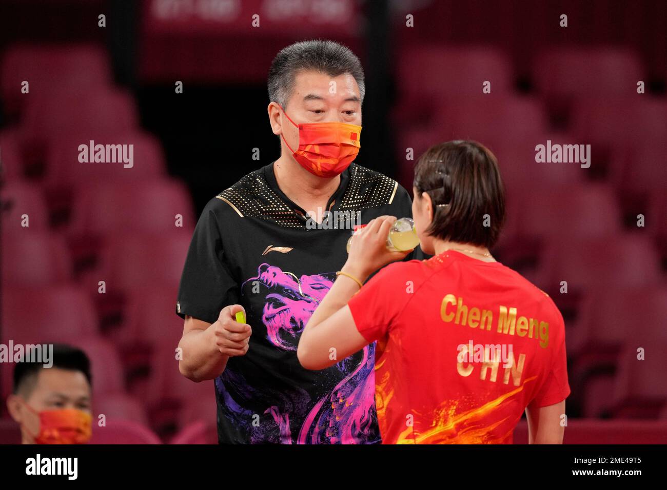 China's Chen Meng talks to her coach during the table tennis women's ...