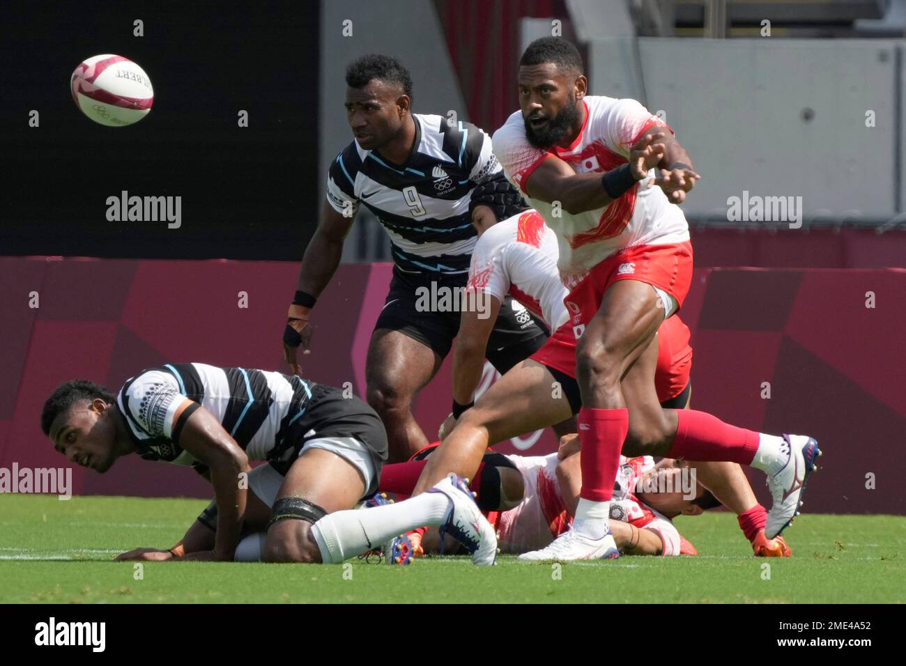Japan's Lote Tuqiri, right, passes the ball during their men's rugby ...