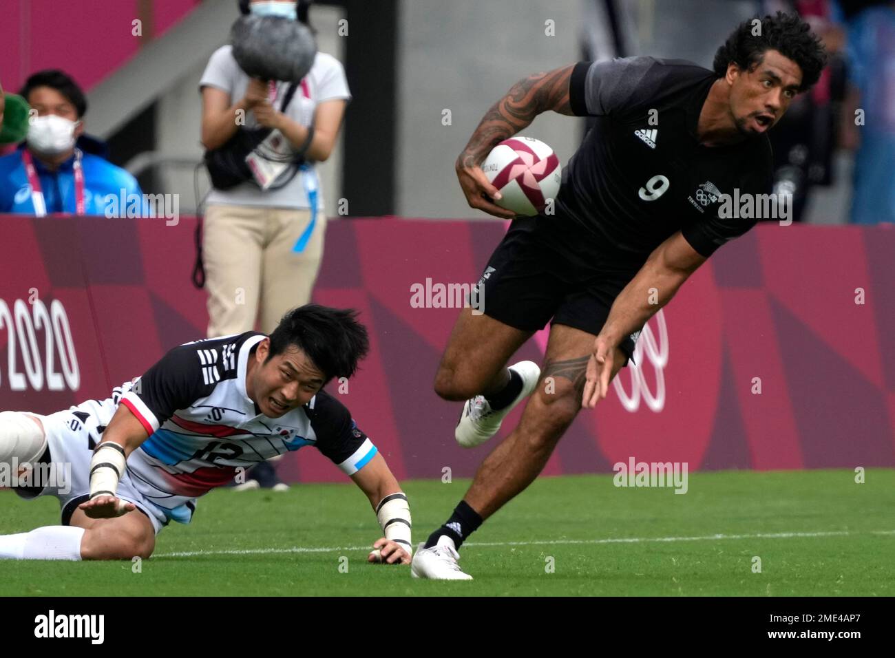 New Zealand's Regan Ware, right, runs past, South Korea's Jeong Yeon ...