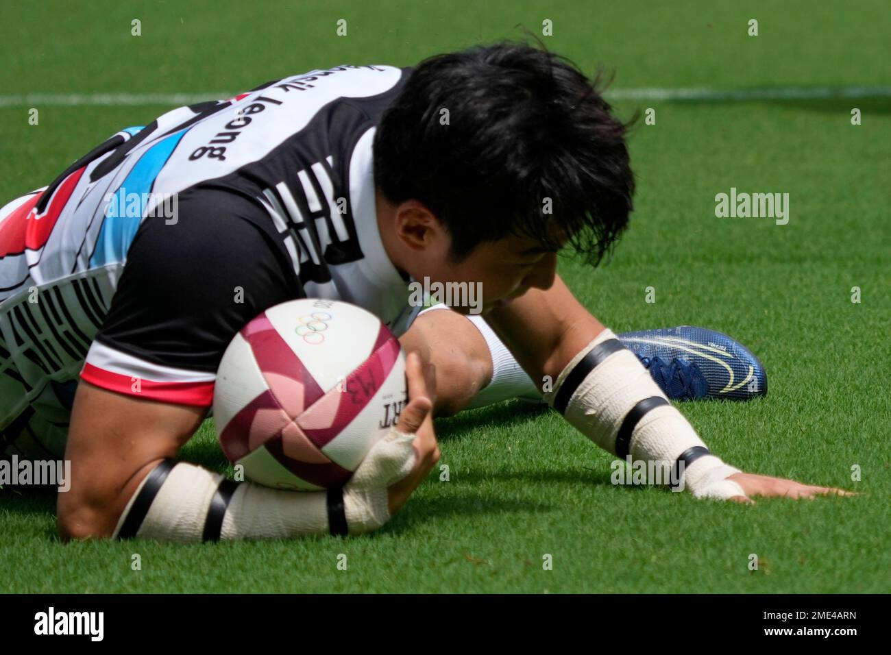 South Korea's Jeong Yeon-sik scores a try against New Zealand during ...