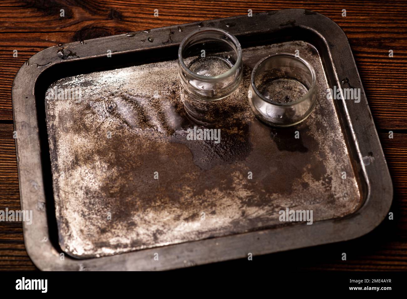Old rusty steel tray with empty glass bowls Stock Photo - Alamy