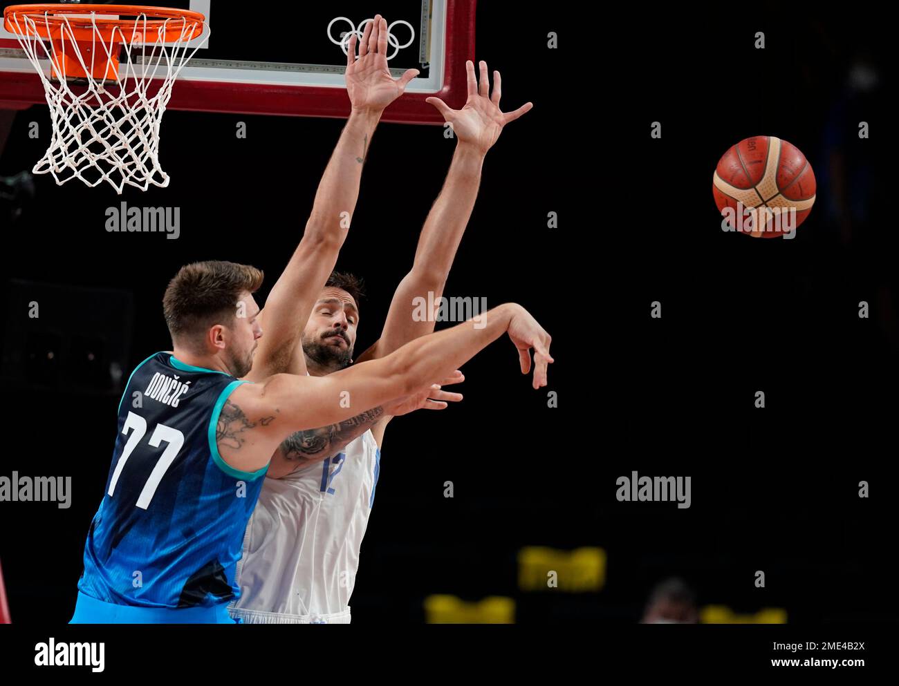 Slovenia's Luka Doncic (77) passes over Argentina's Marcos Delia (12 ...